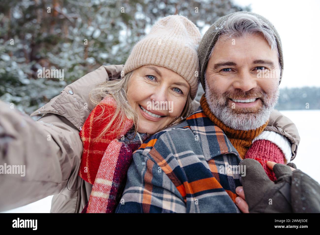 Mature couple looking happy and making selfie Stock Photo - Alamy