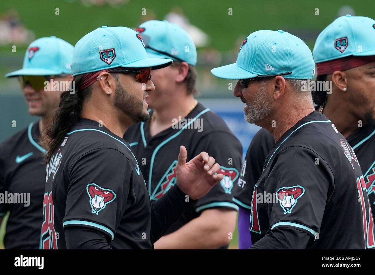 Arizona Diamondbacks manager Torey Lovullo, right, gives a hug to ...