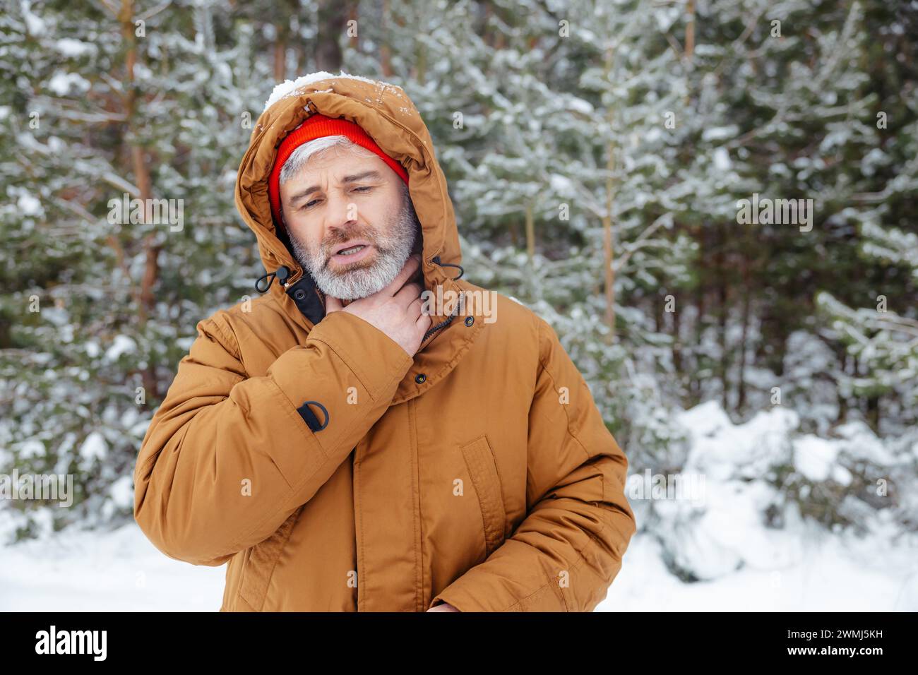Man in a winter forest looking sick and unwell Stock Photo - Alamy