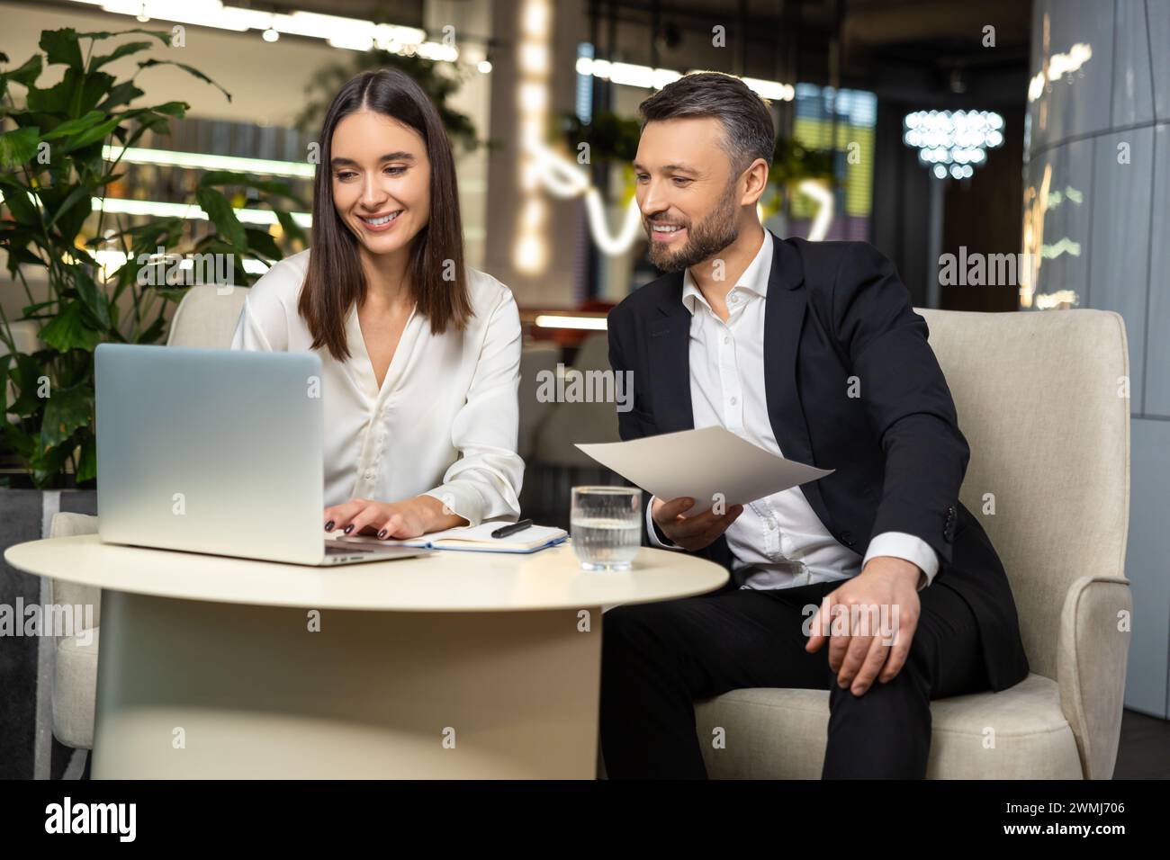 Two colleagues working on project together and looking involved Stock ...