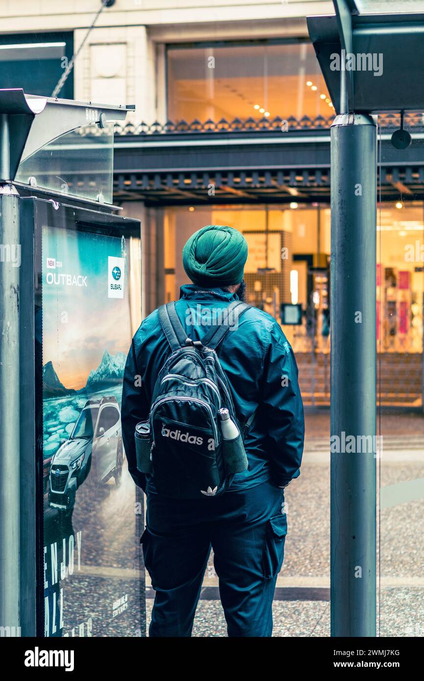 Vancouver, Canada - Feb 21 2024: A tall man wearing a dastar is waiting ...