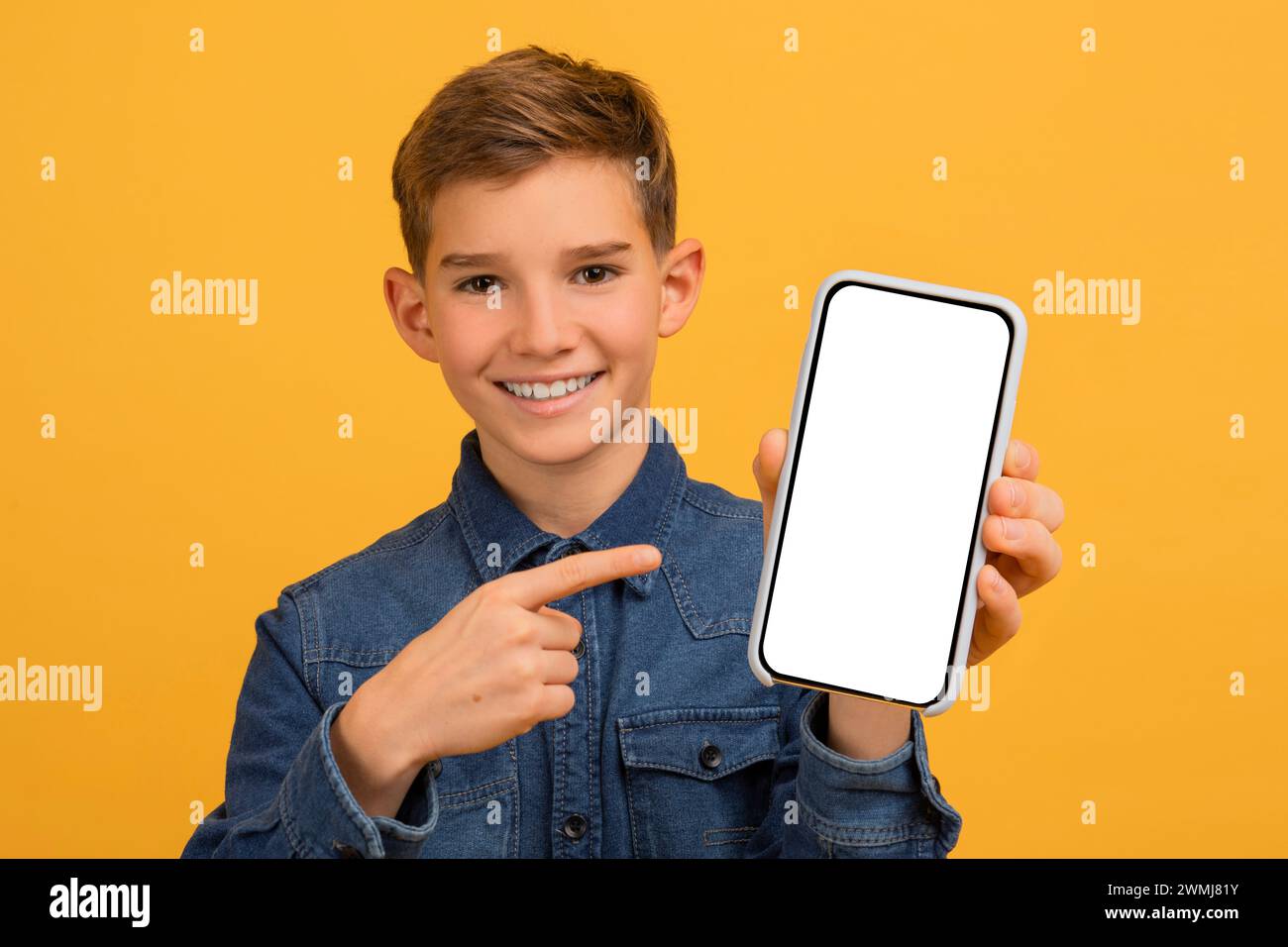 Smiling Handsome Teen Boy Pointing At Empty Smartphone Screen In His ...