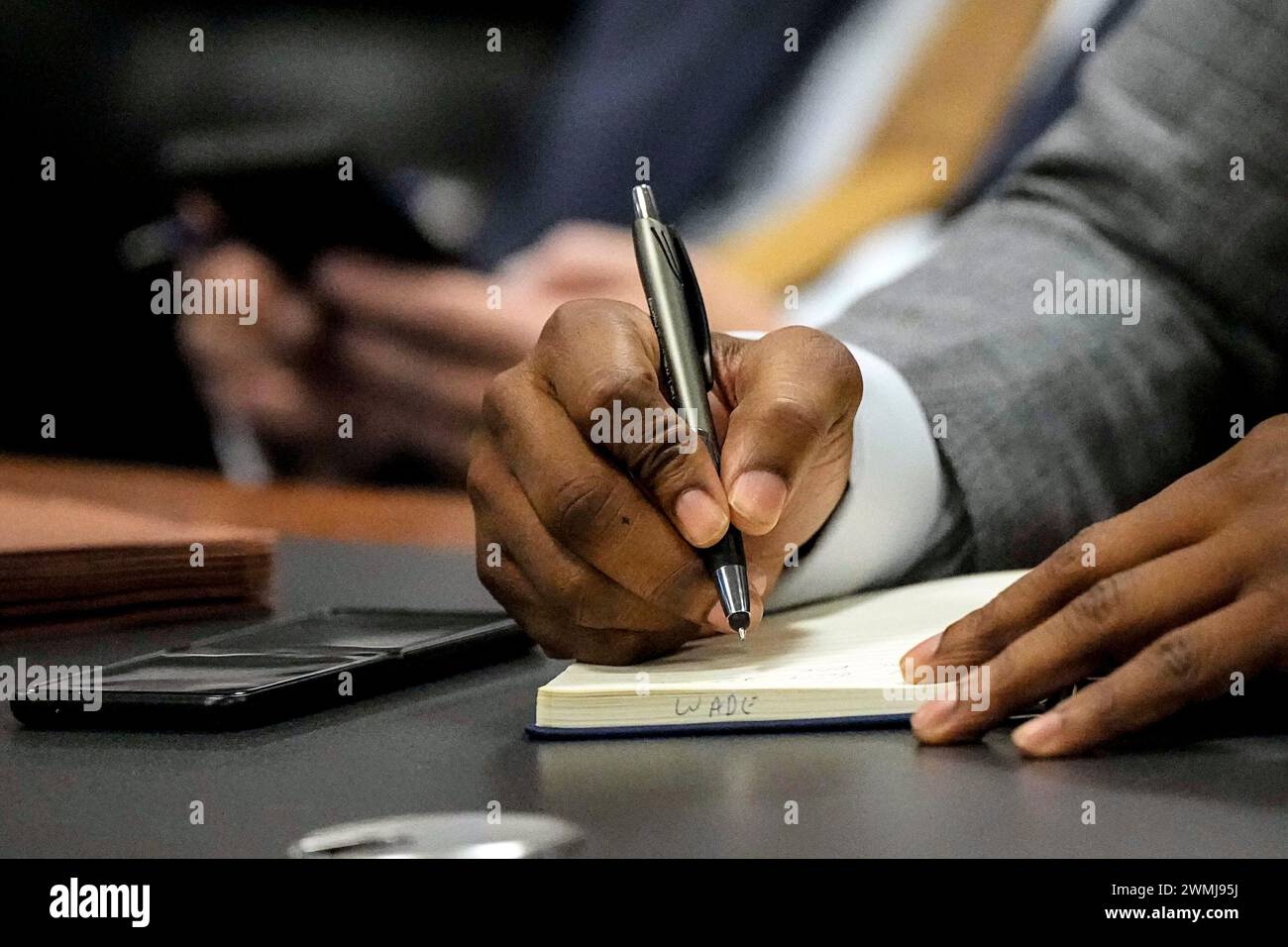 Special prosecutor Nathan Wade writes in a notebook before a meeting ...