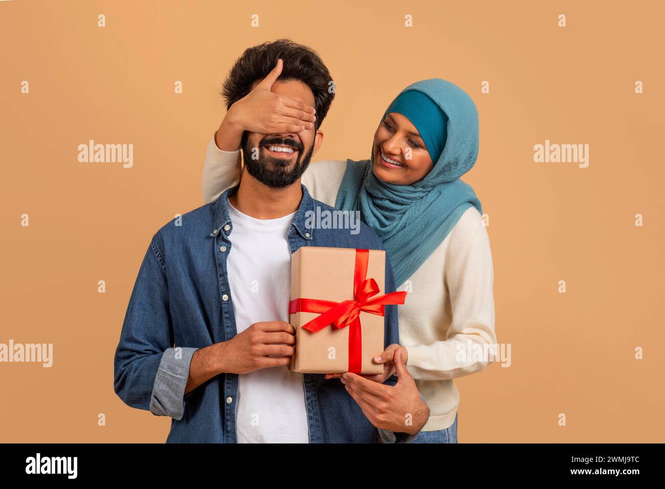 Woman covering husbands eyes hi-res stock photography and images - Alamy