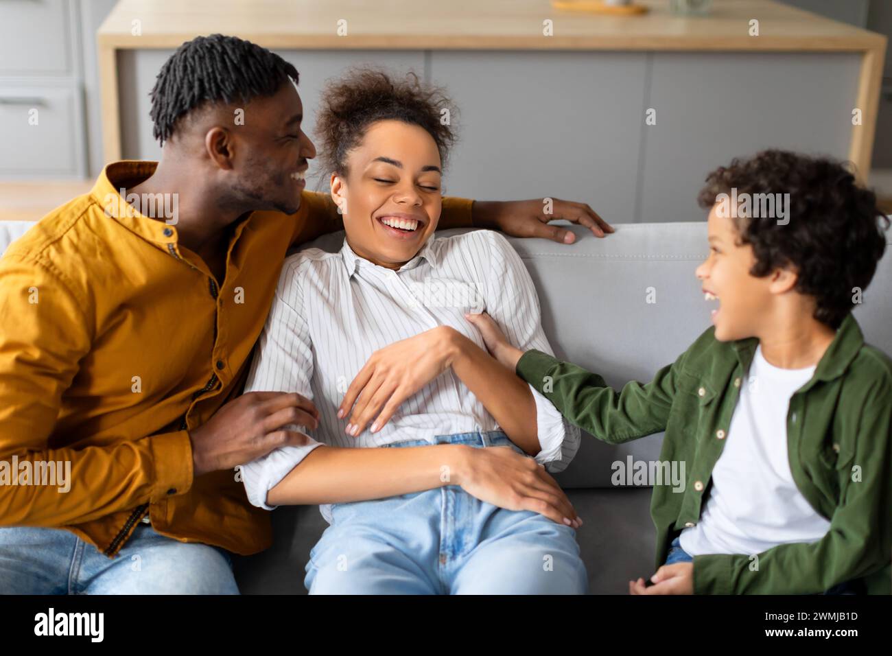 Playful african american family time with laughing child and joyful ...