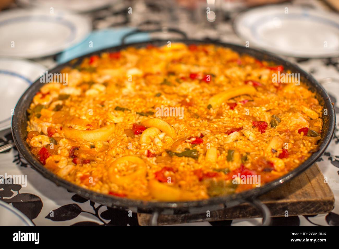 A freshly cooked Spanish seafood paella displayed on a table Stock ...