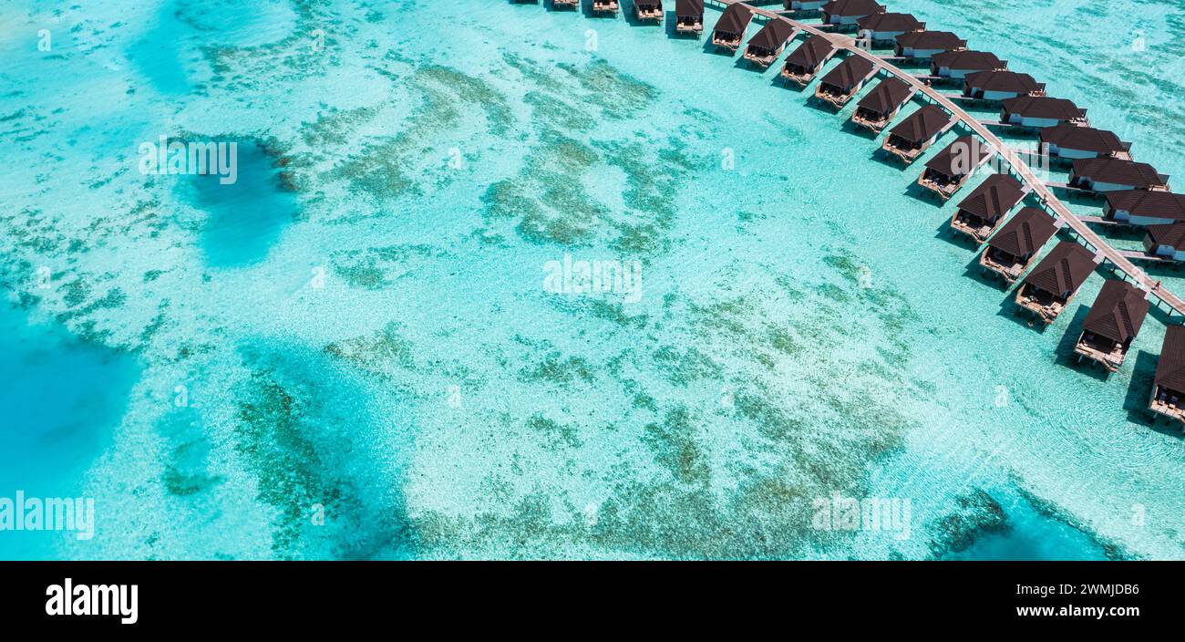 Aerial view tropical island in turquoise water. Luxurious over water ...