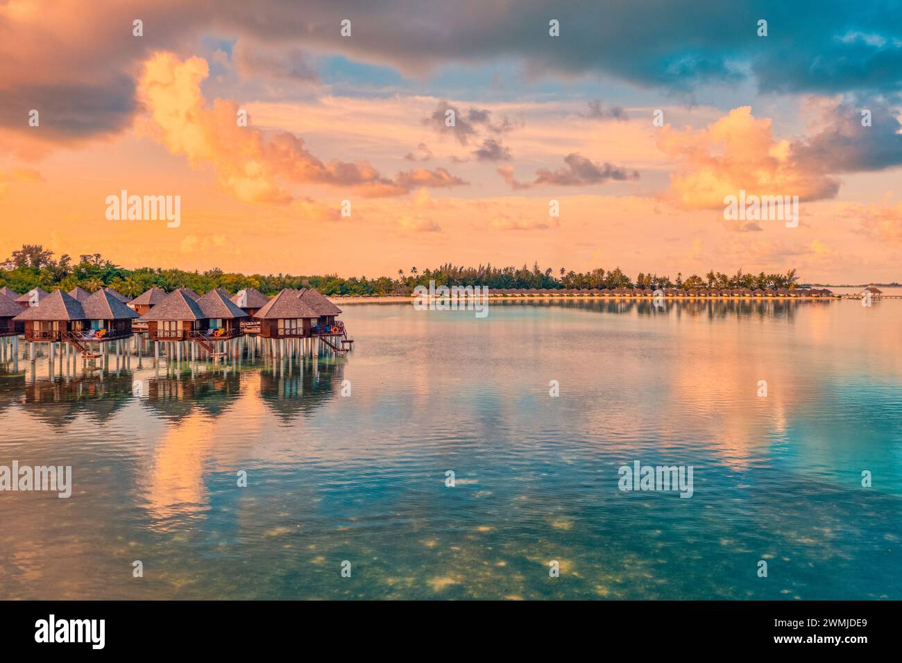 Aerial sunset panoramic landscape luxury tropical resort water villas ...