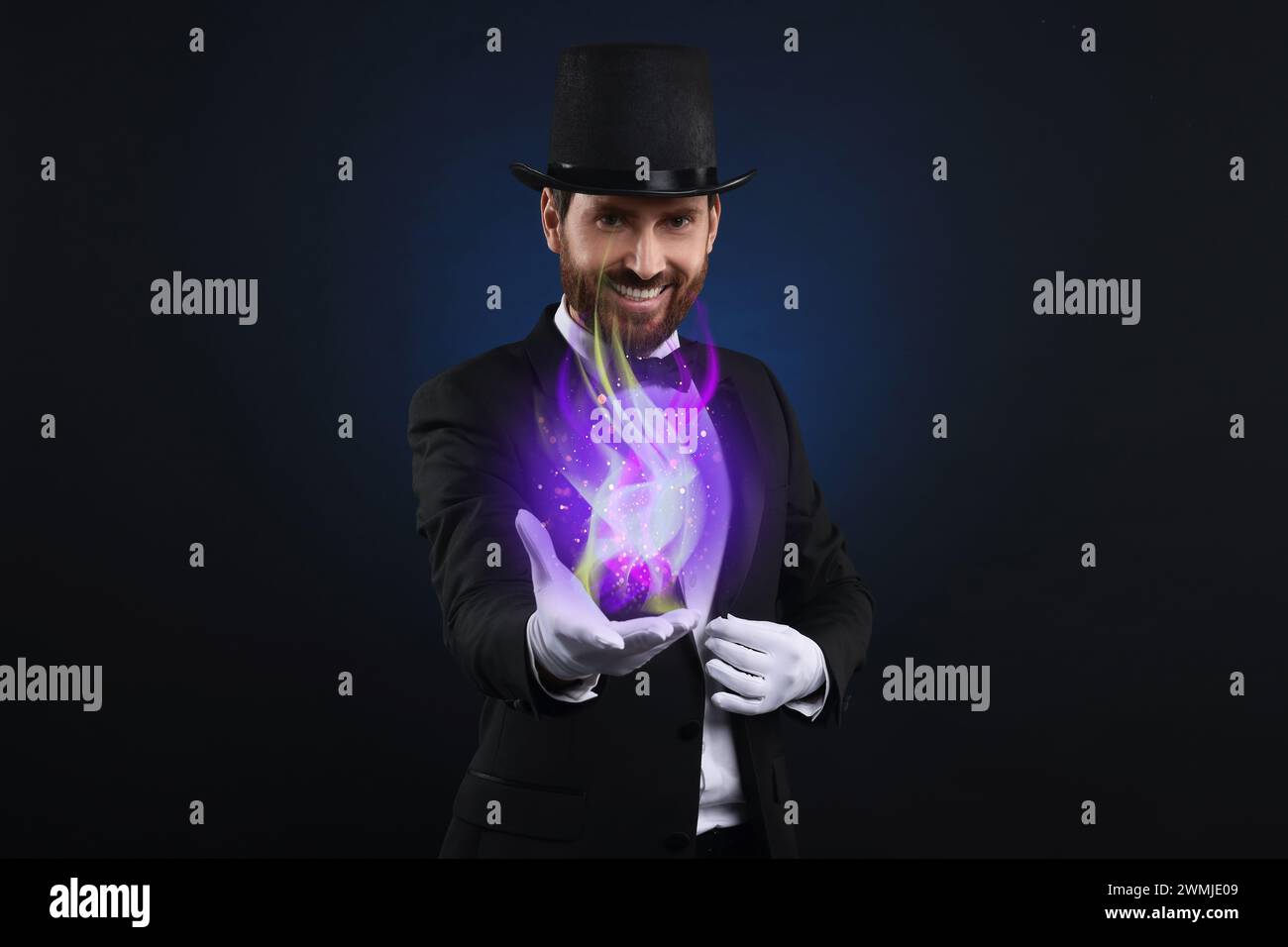 Magic and sorcery. Magician with fantastic light on dark background ...