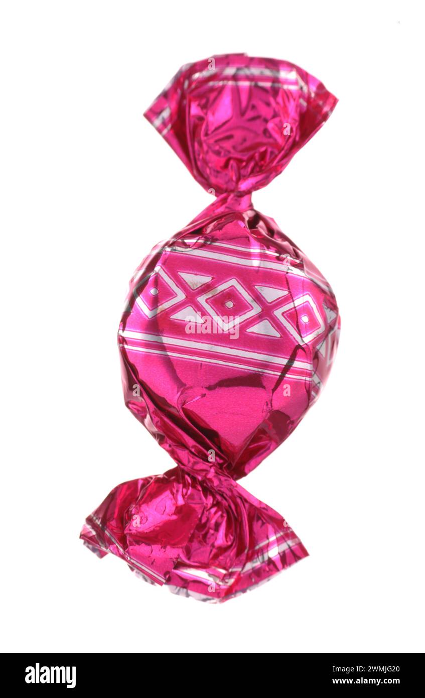 Candy in bright pink wrapper isolated on white Stock Photo - Alamy
