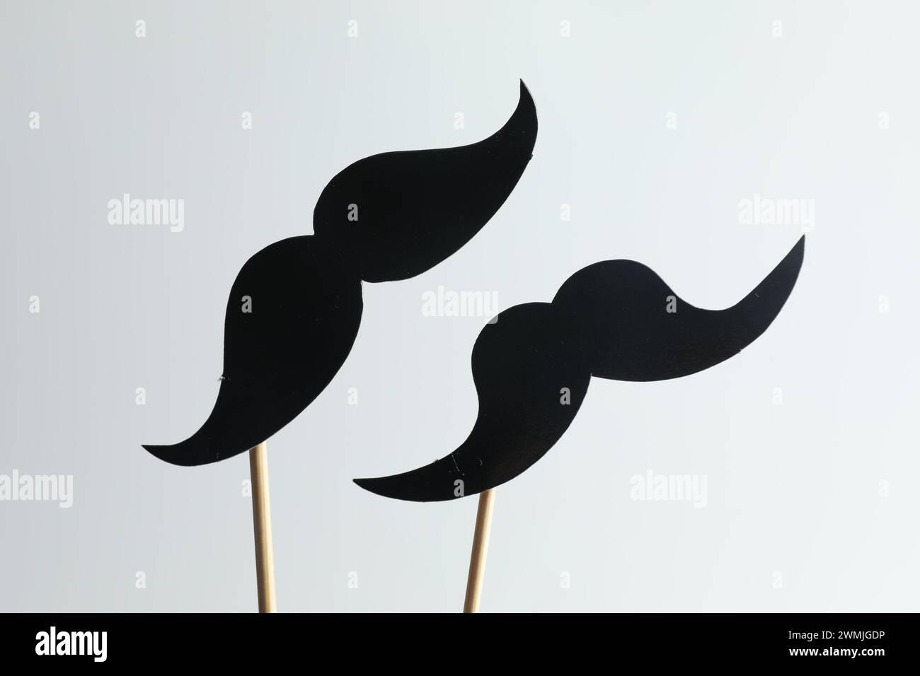 Fake paper mustaches party prop on light background Stock Photo - Alamy