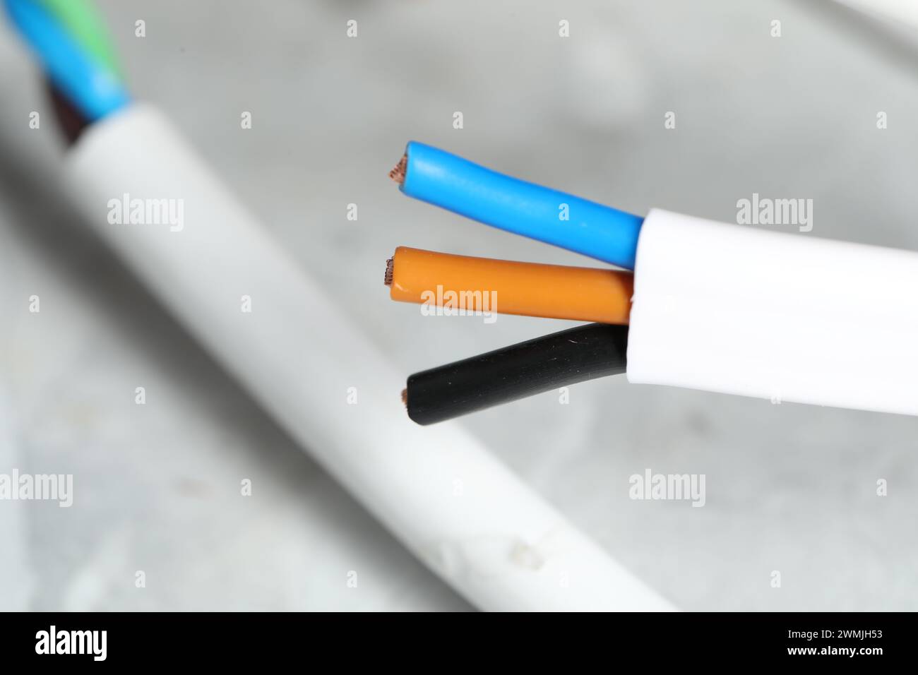 Colorful electrical wire on gray background, closeup Stock Photo - Alamy