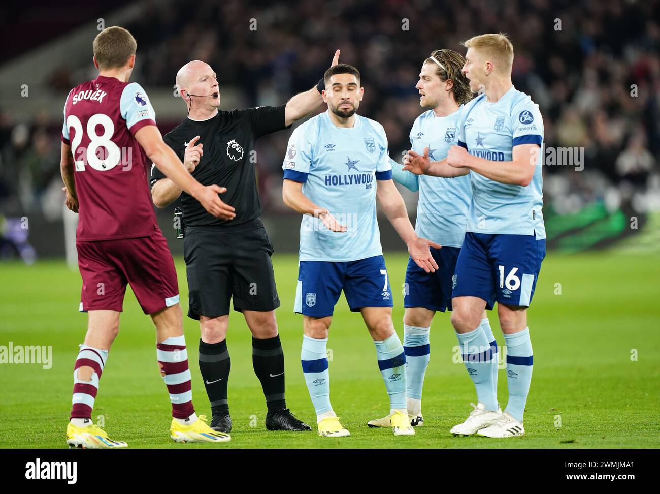 Players speak to referee Simon Hooper during the Premier League match ...