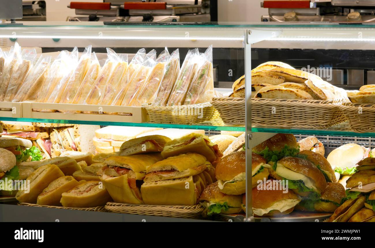 many Delicious sandwiches and filled rolls on sale in the display case ...