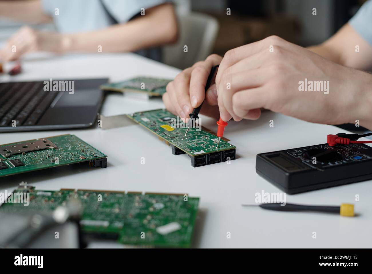 Unrecognizable technician of repair service center with electric ...