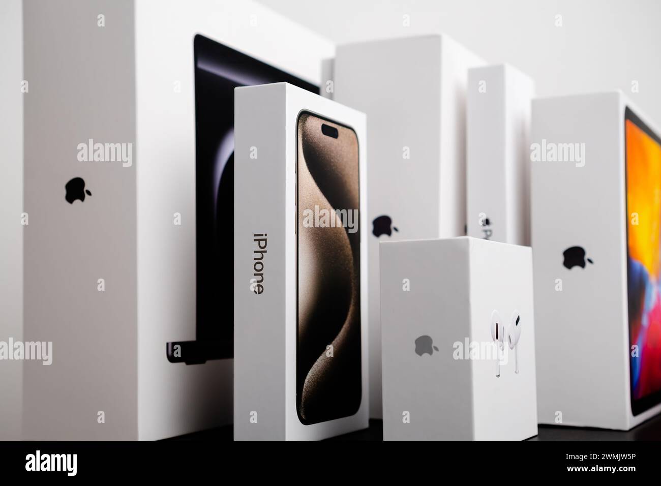 BERLIN , GERMANY - FEBRUARY 14 2024: MacBook Pro. iPhone, Air Pods, iPad boxes from Apple on the ...