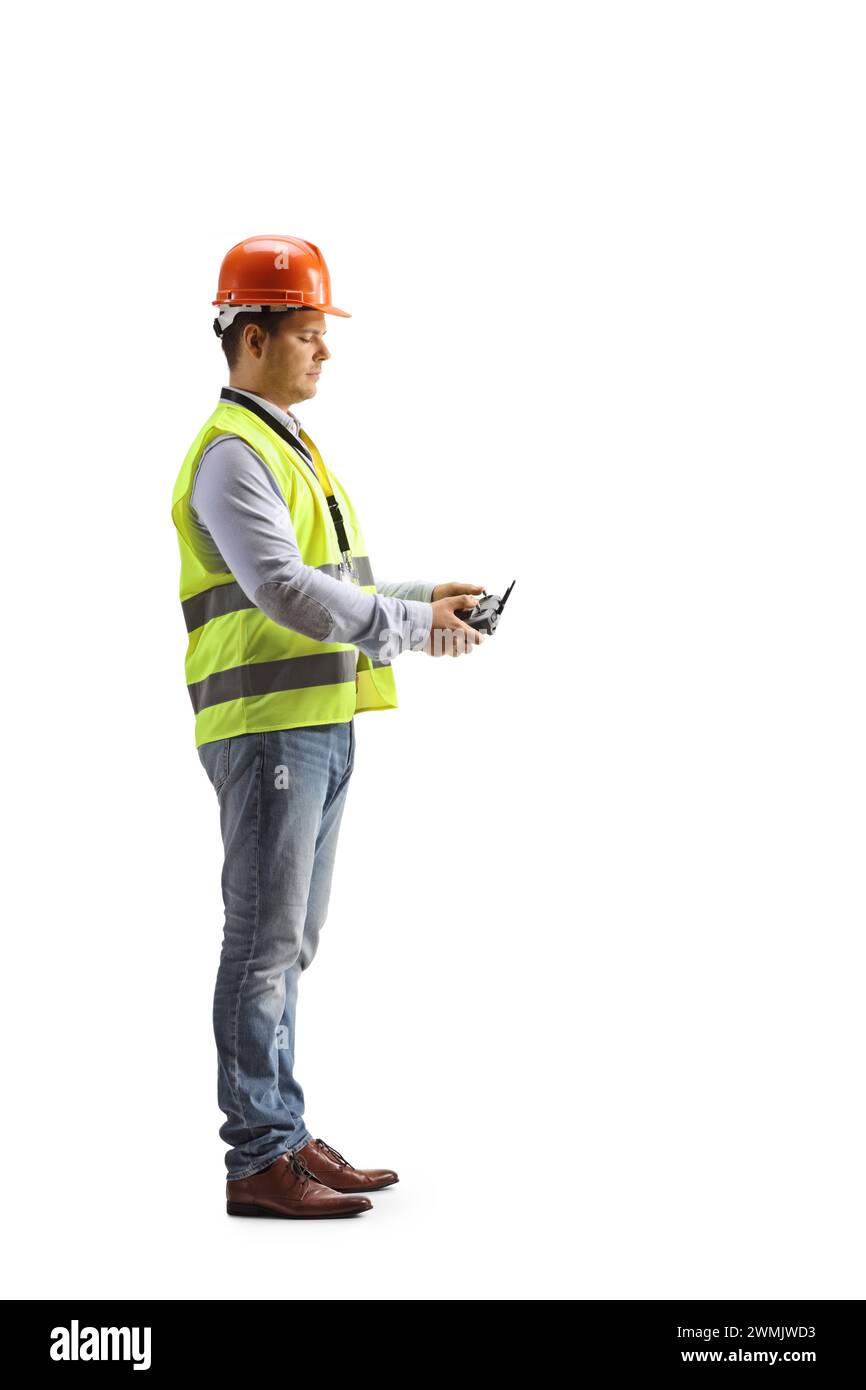 Engineer in a safety vest looking at a drone remote controller isolated ...