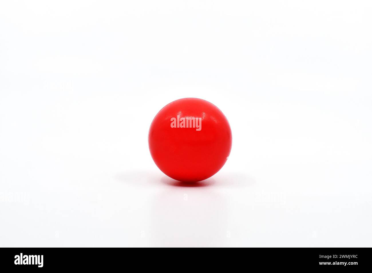 Single red ball isolated on a plain white background. Copy space. No ...