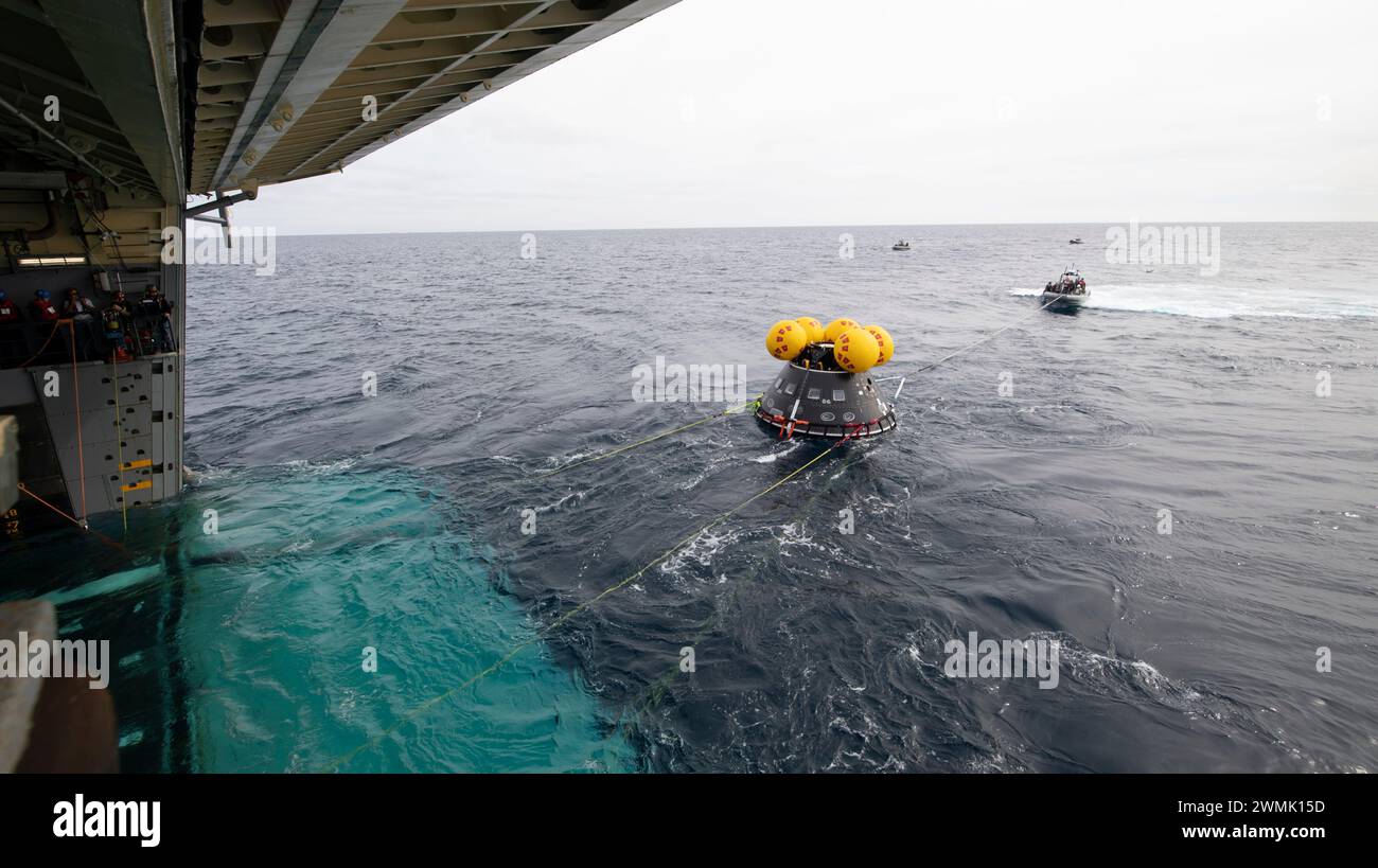 U.S. Navy Sailors inside a rigid hull inflatable boat maneuver NASA’s ...