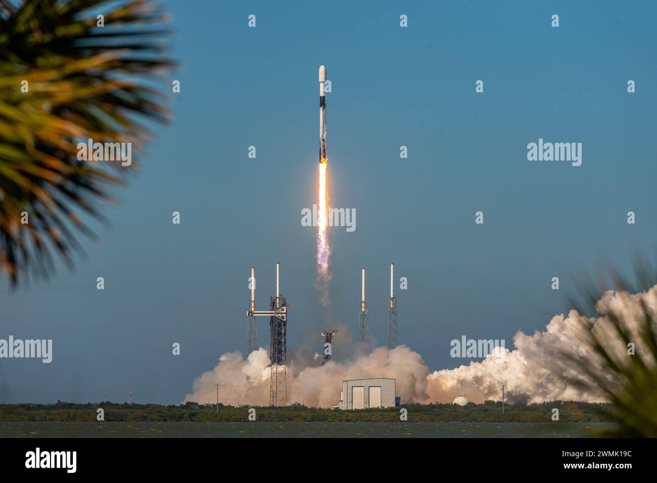 A Falcon 9 rocket carrying a telecommunications satellite launches from ...