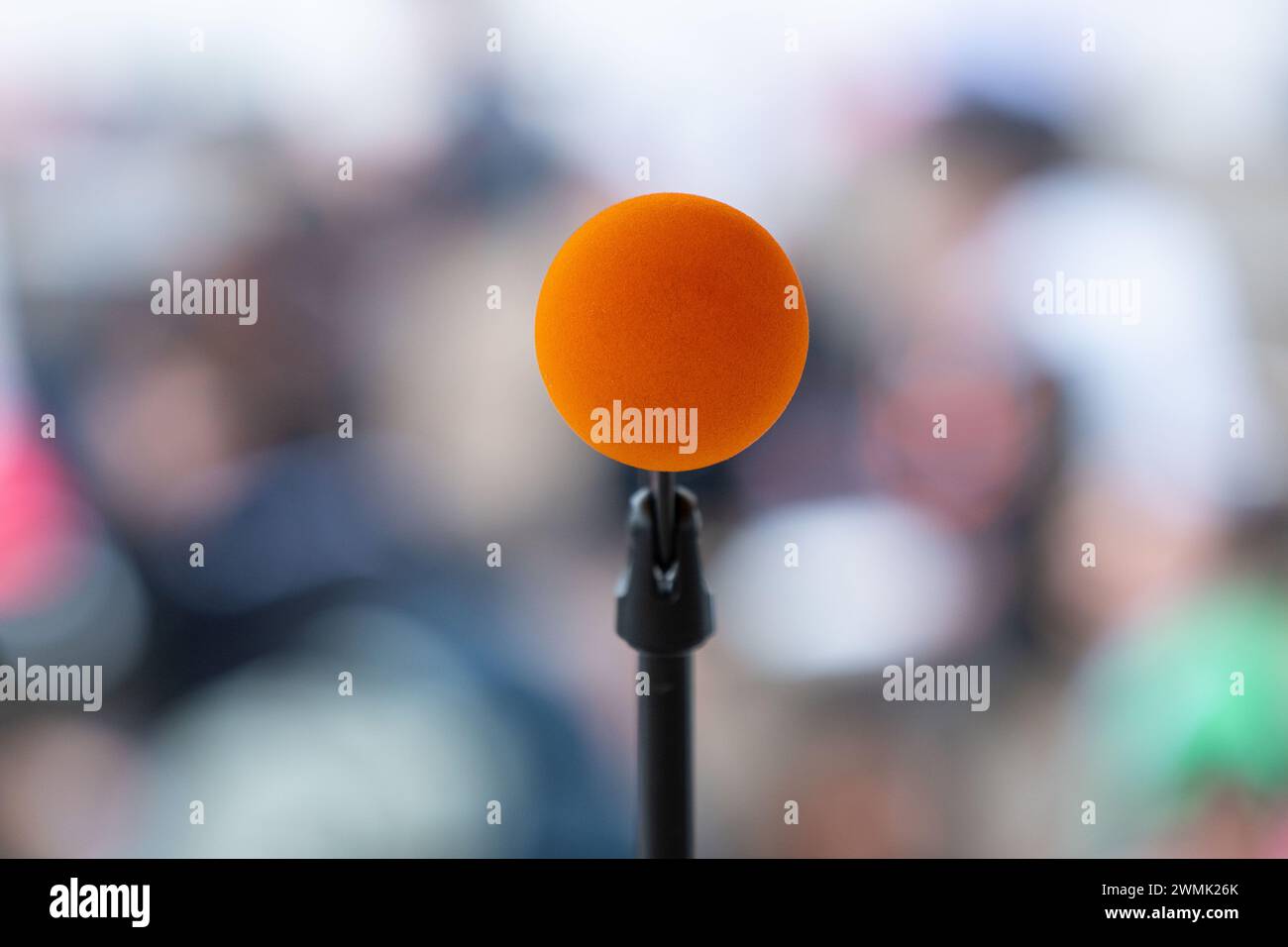 Life event . Vibrant orange microphone head. Isolated speech. Blurry ...
