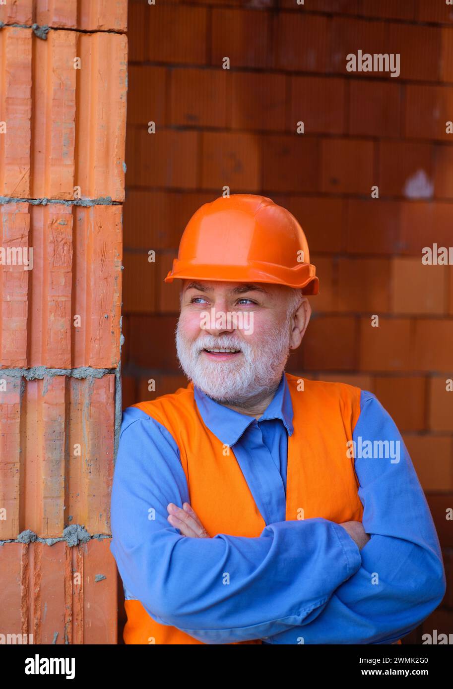 Construction worker in safety vest and hard hat. Smiling architect ...