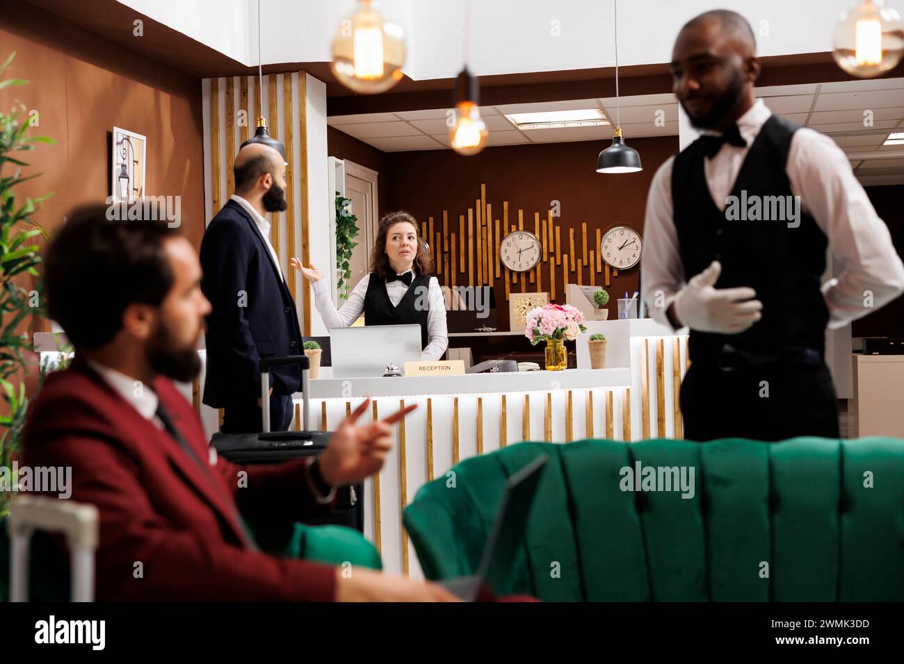 Front desk staff welcoming traveller, ensuring pleasant stay and check ...