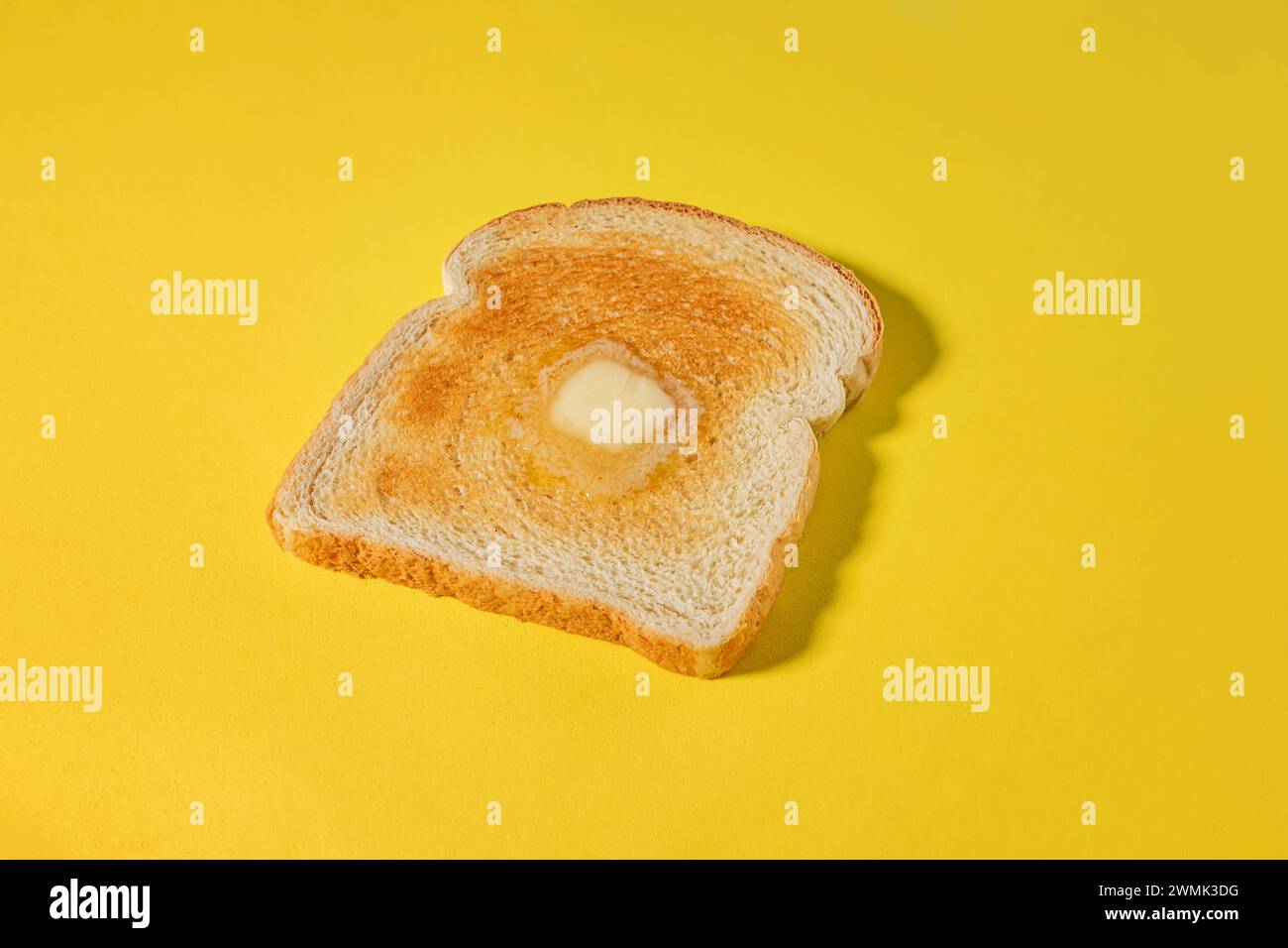 Bread slice, toast with a slice of butter melting, isolated on yellow ...