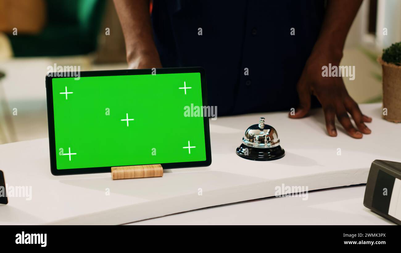 Tourist asking about greenscreen display, pointing at digital tablet on ...