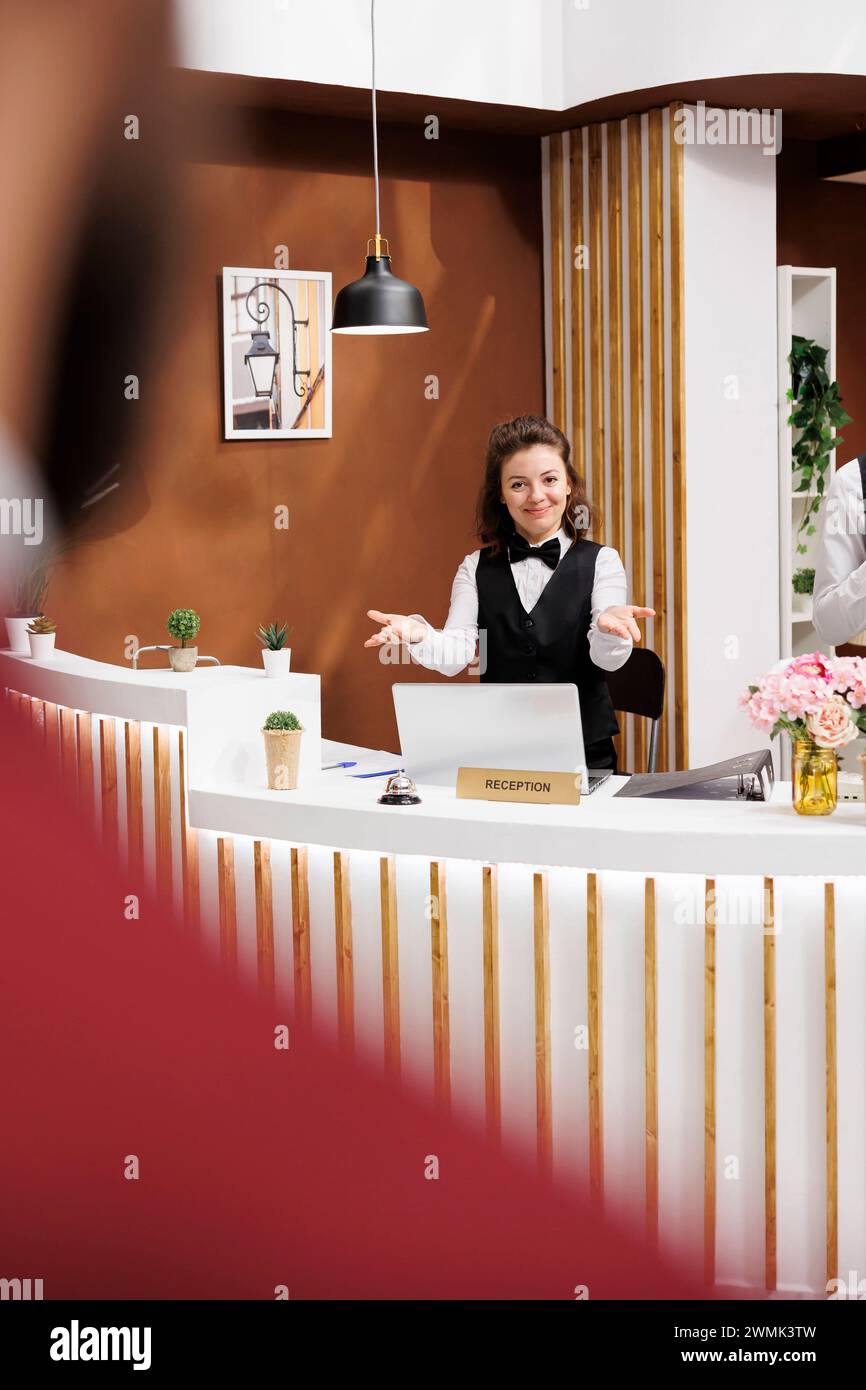 Friendly employee greeting guest in lobby, welcoming businessman at ...
