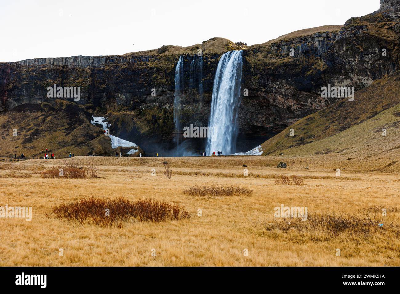 Spectacular waterfall in iceland with stream falling off hills ...