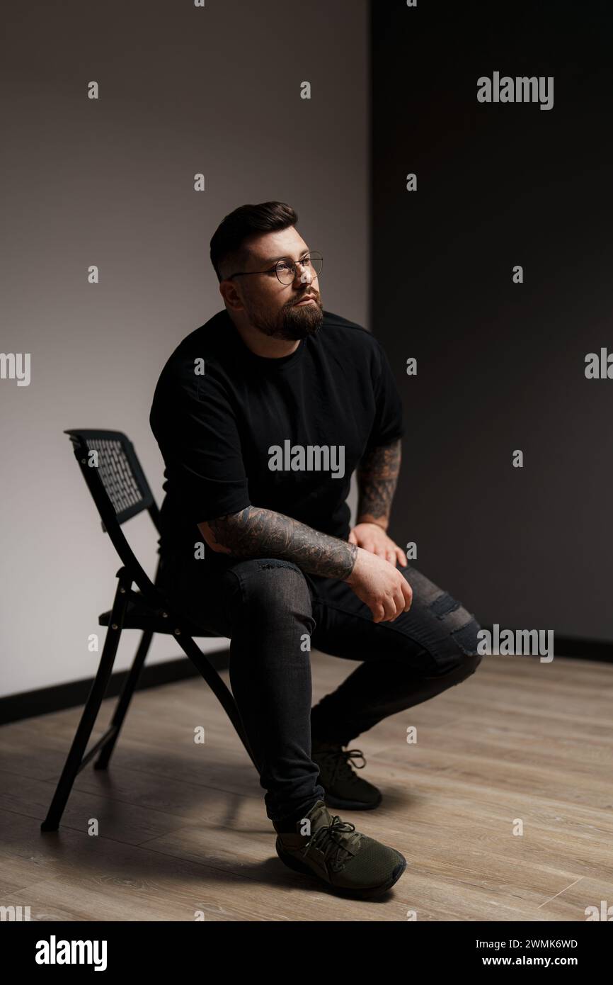 Stylish Man Seated in Contemplation Stock Photo - Alamy