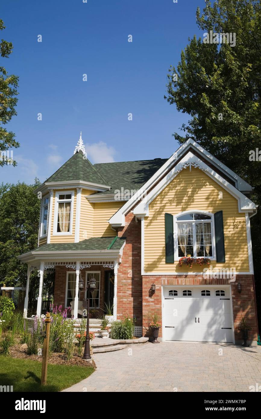 Two storied red brick and yellow clapboard Victorian style home with ...