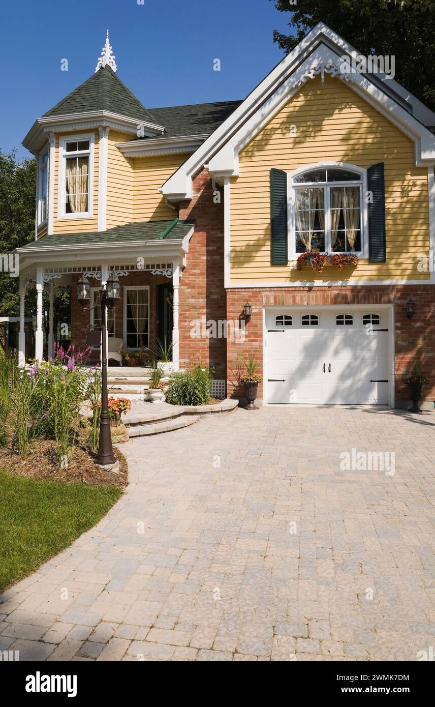 Two storied red brick and yellow clapboard Victorian style home with ...