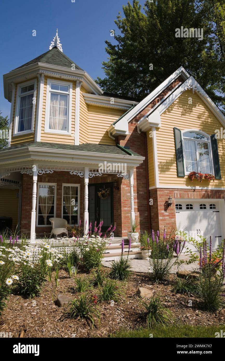 Two storied red brick and yellow clapboard Victorian style home with ...