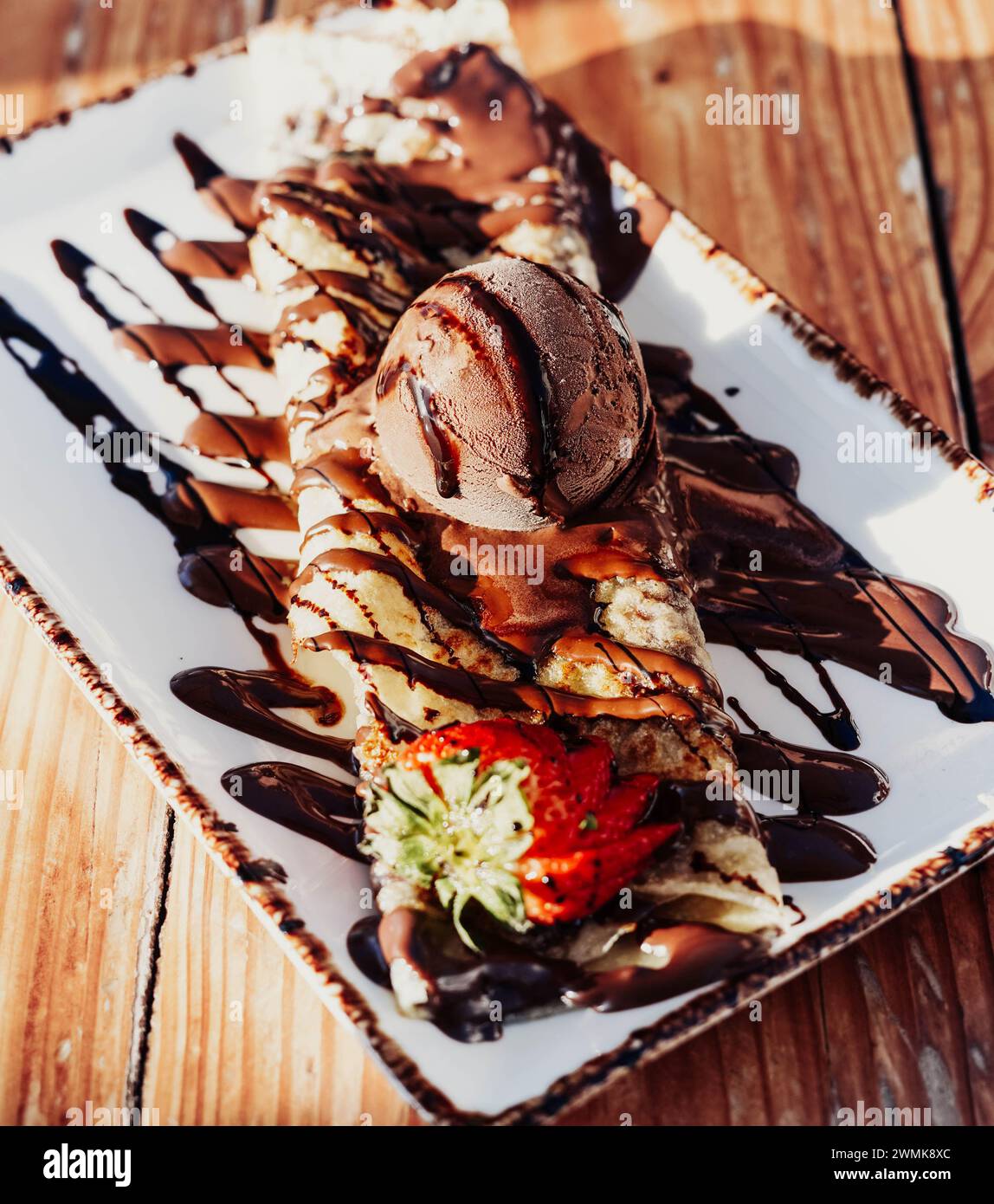 Delicious nutella and chocolate syrup crepe, with a scoop of ice cream ...
