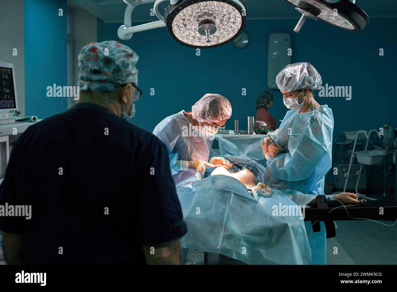 Group of surgeons in operating theater. Medical team performing surgery ...