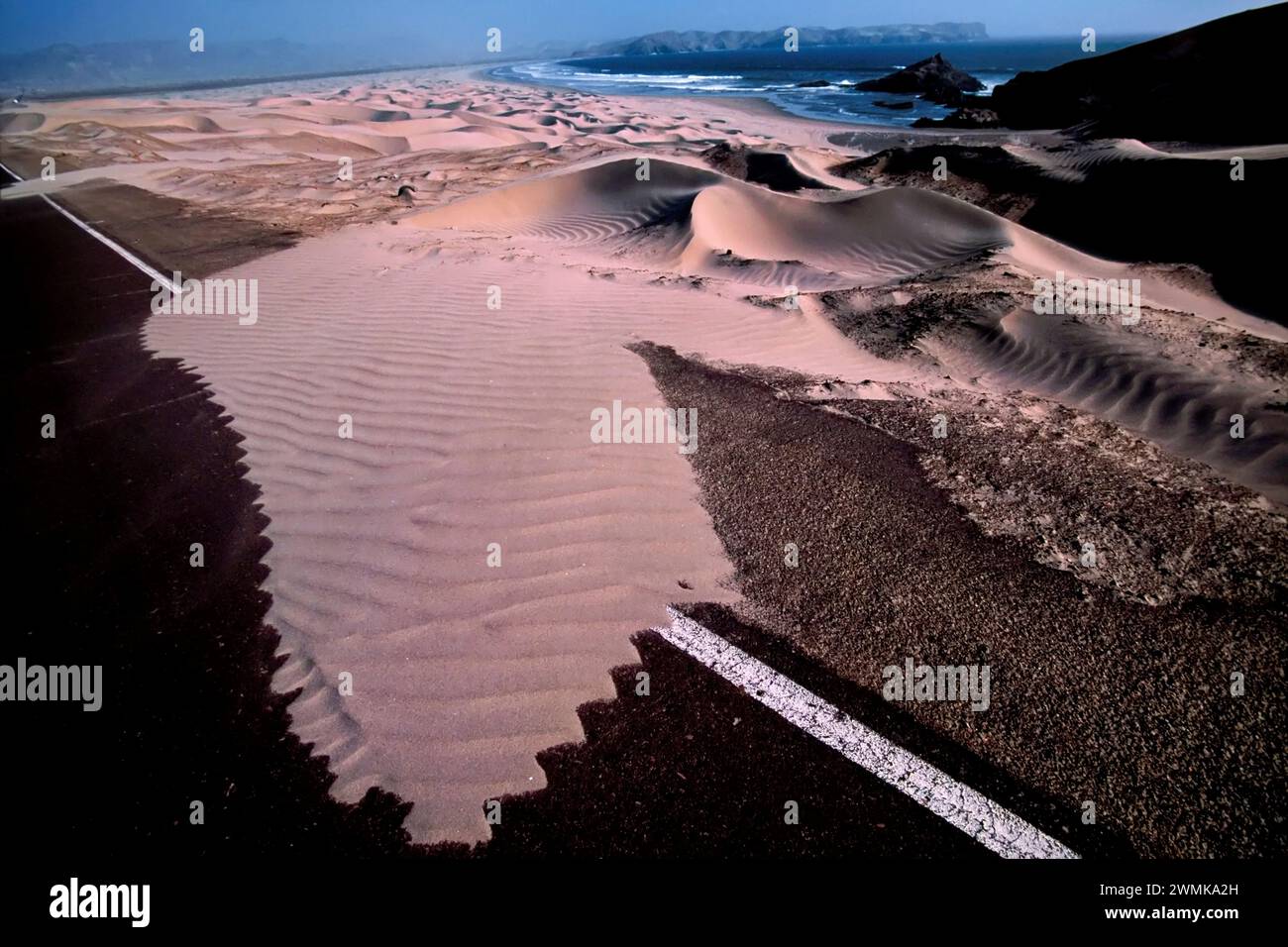 Sand dunes encroach on the Pan American Highway, on Peru's coast blown ...