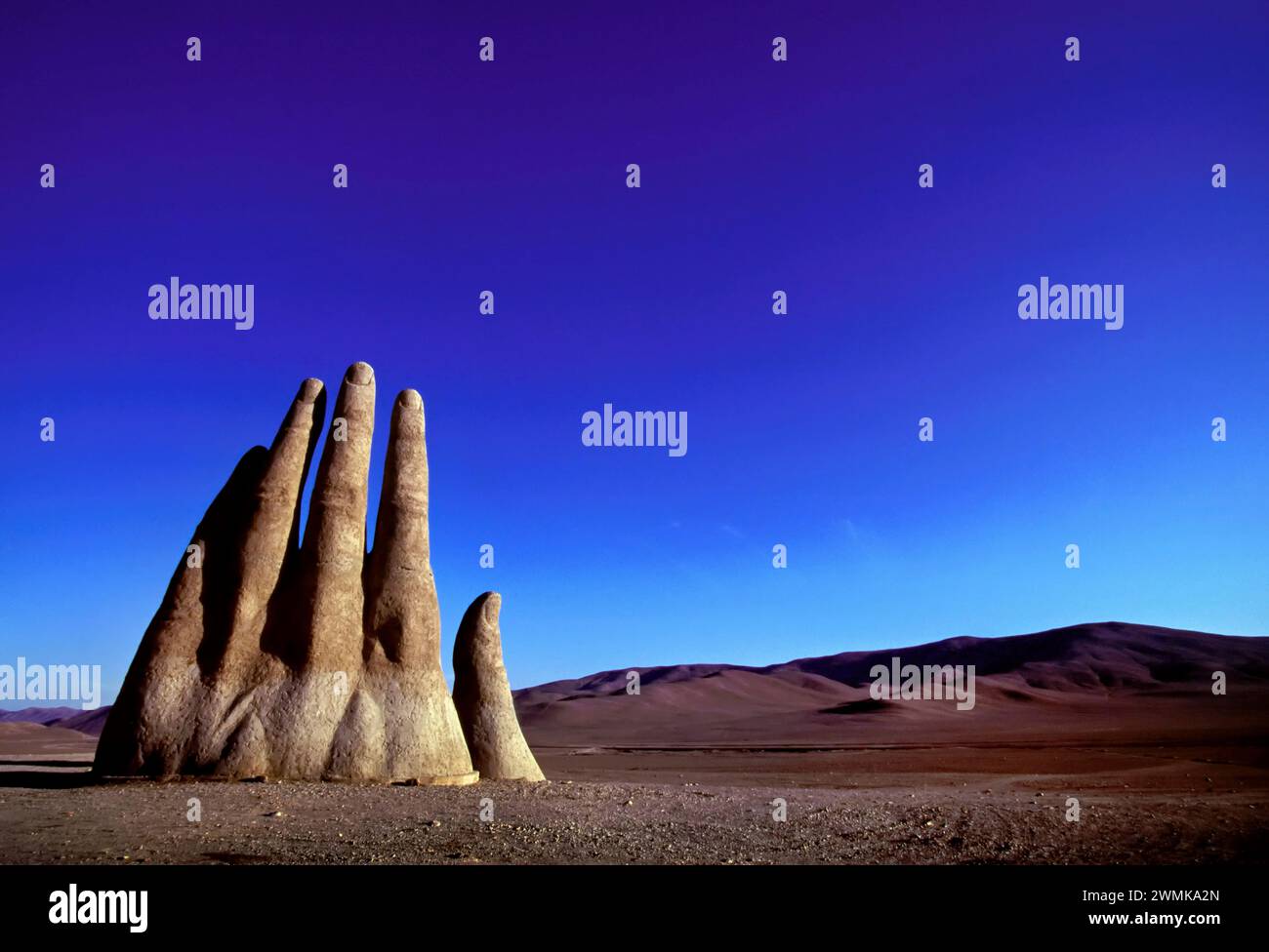 Giant hand sculpture (Mano De Desierto constructed by Chilean sculptor Mario Irarrázabal) rises ...