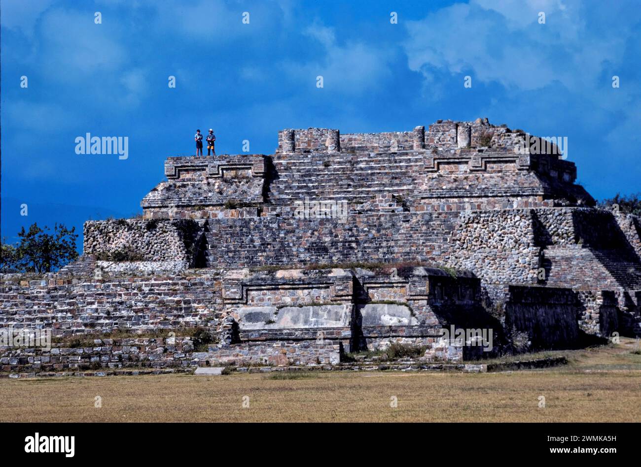 Tourists stand on the ruins of Monte Alban, a Zapotec capital. It is a ...