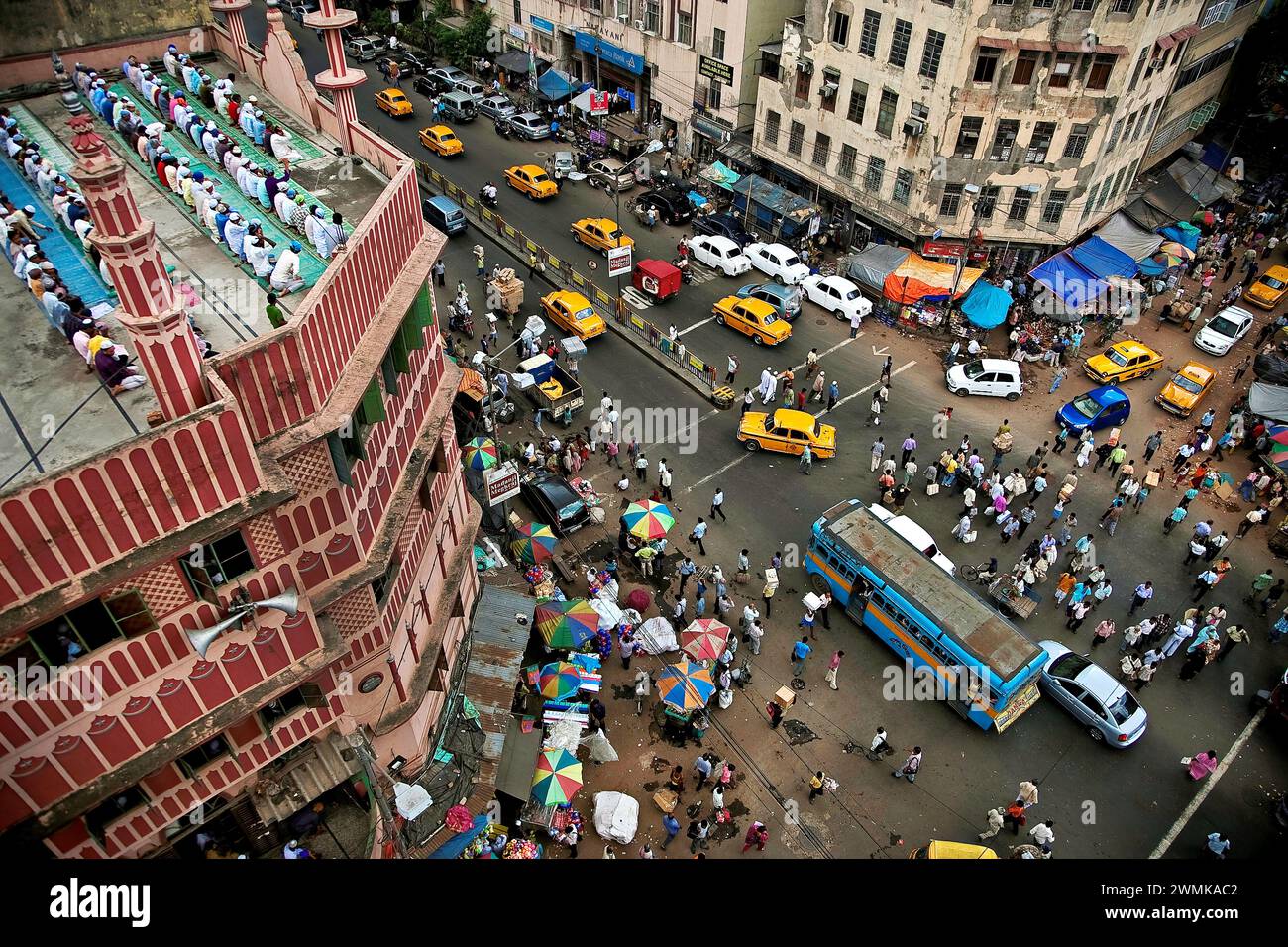 Indian Muslims at the call to prayer on the roof of a Kolkata mosque ...