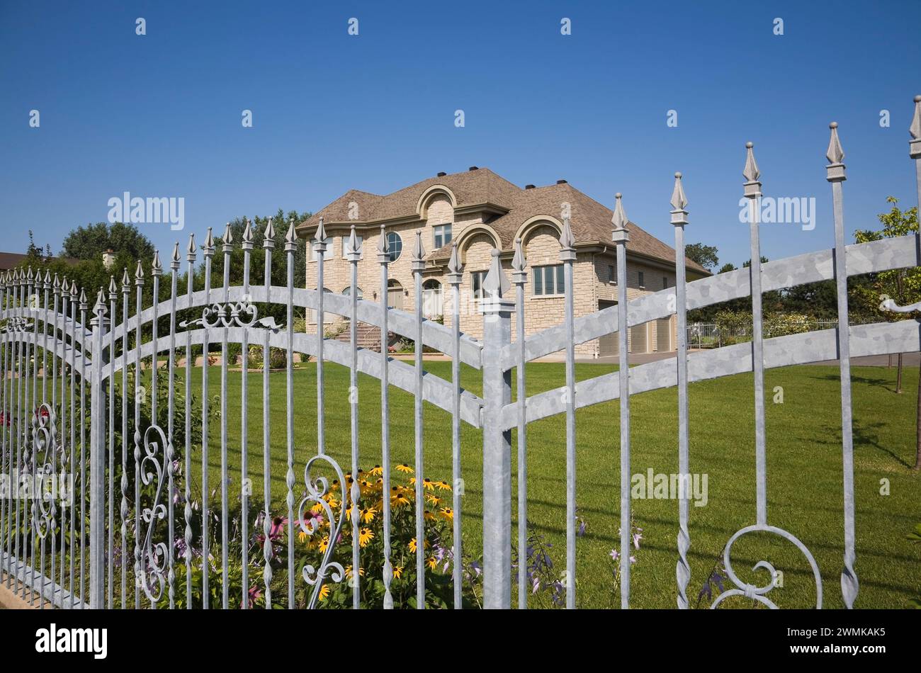 Luxurious two story tan cut stone home with landscaped front yard and ...