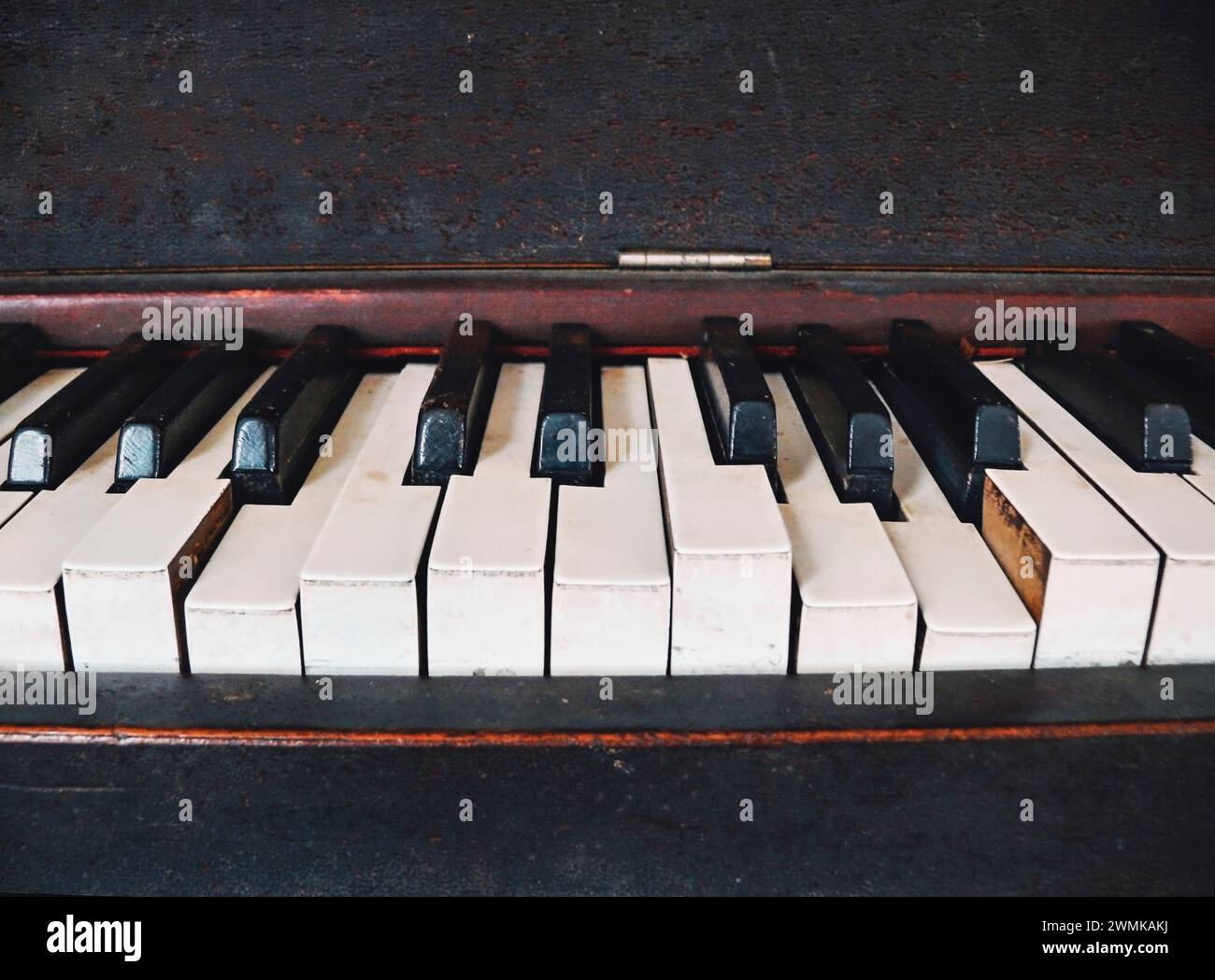 Keys on an old piano show their age as their action has deteriorated ...