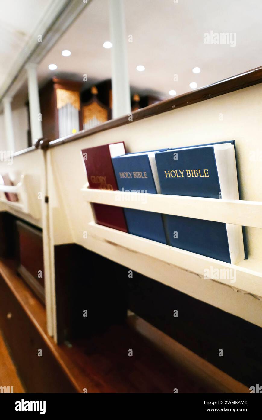 Bibles rest in a rack along the back of a church pew; Alexandria ...