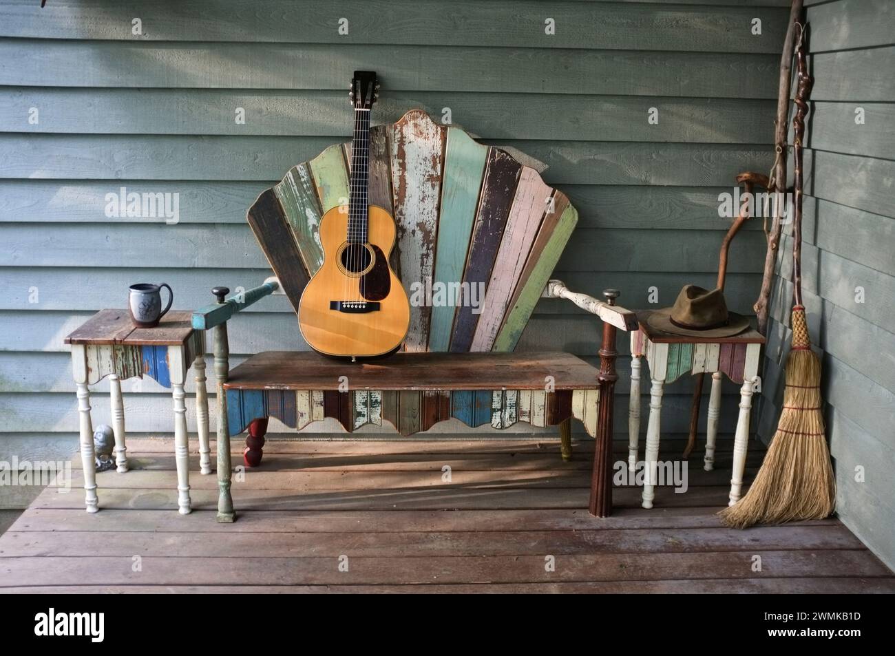 Acoustic guitar rests on a repurposed bench on a front porch Stock ...