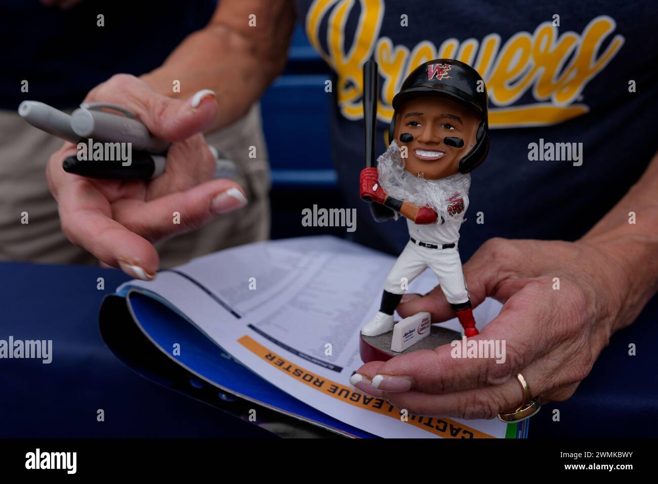 Suzi Perlewitz, of Appleton, Wis., holds a signed bobblehead of ...