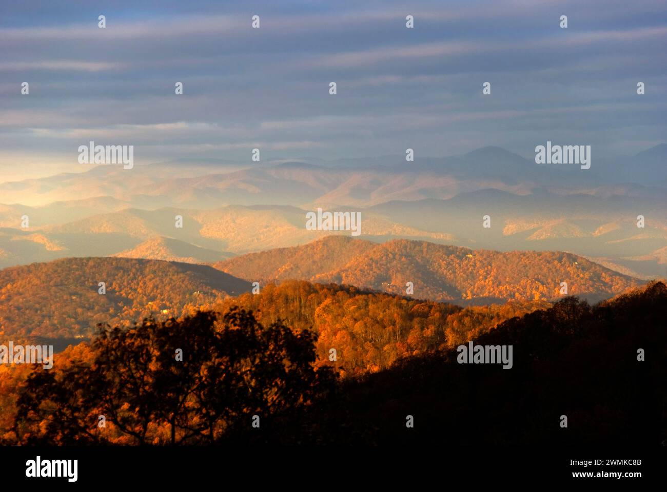 Early morning sunlight illuminates the autumn colors over the Blue ...