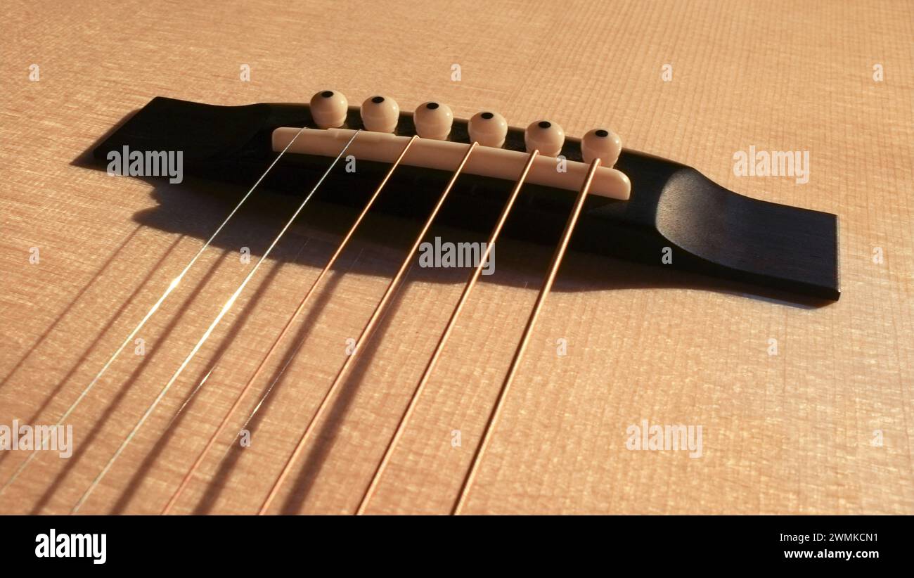 Close up of the bridge on an acoustic steel string guitar Stock Photo ...