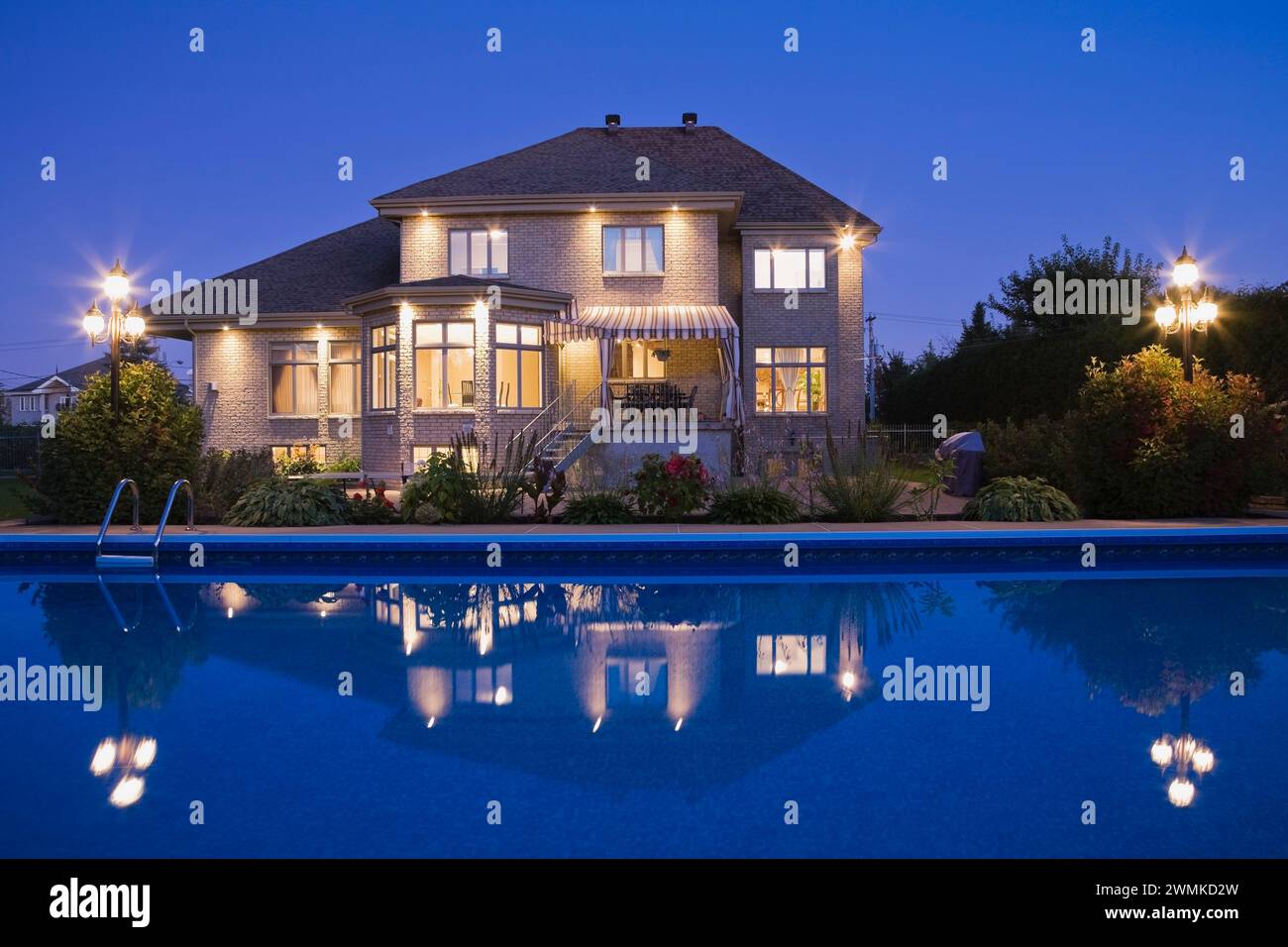 Luxurious two story tan cut stone home with landscaped backyard and In ...