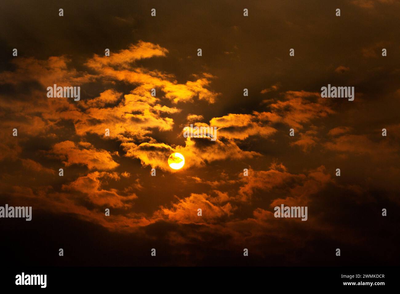 Colourful dramatic orange glow of the sun and clouds; Calgary, Alberta ...